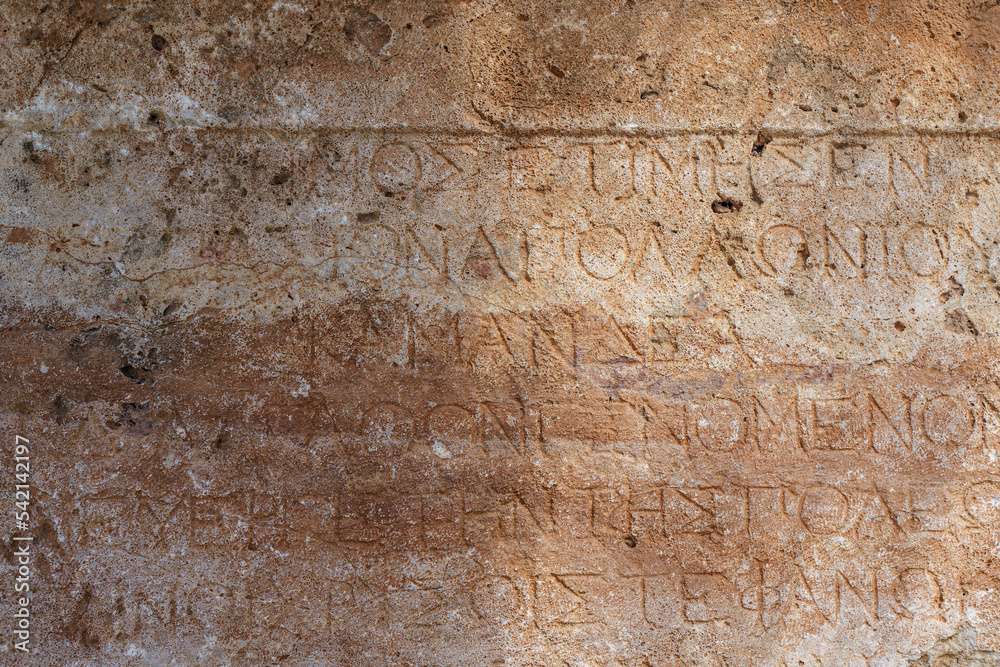 Ancient Greek antique text and inscriptions on the stone wall of the ...