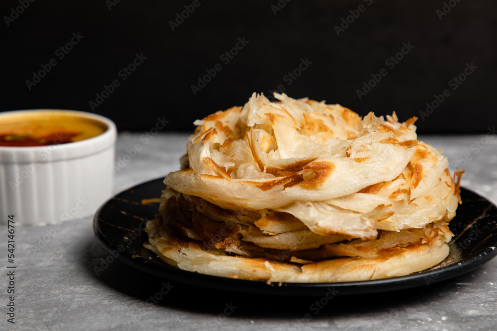 Parotta : an Indian bread made with refined flour which is cooked to ...