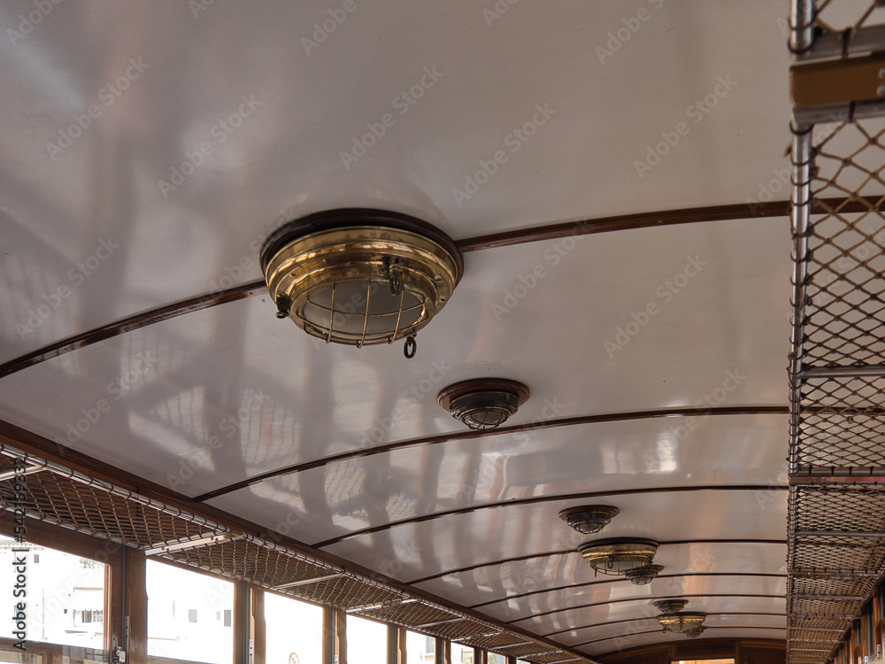 Ceiling of an old railroad car, interior, with round lights and luggage ...