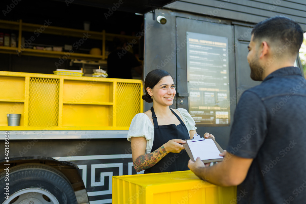 Food stall vendor showing the fast food menu to a customer Stock Photo ...