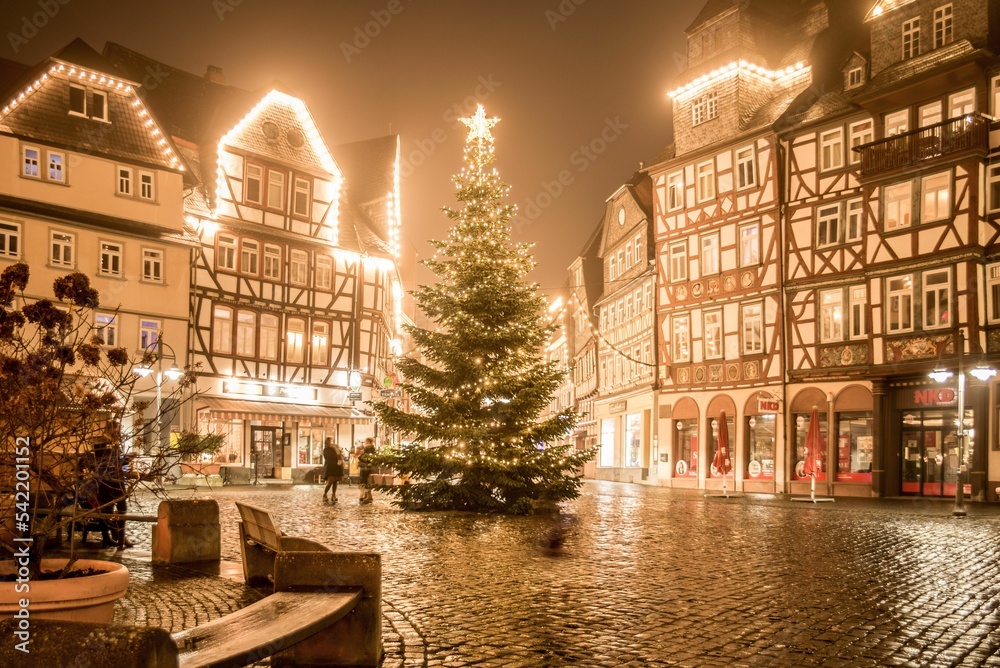 Cozy buildings of Butzbach, Germany surrounding the Christmas tree with ...