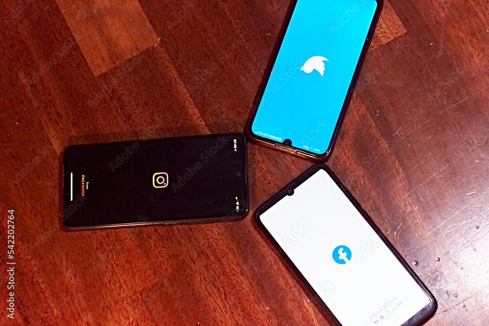 Multiple smart android phones with icons for social media, social ...