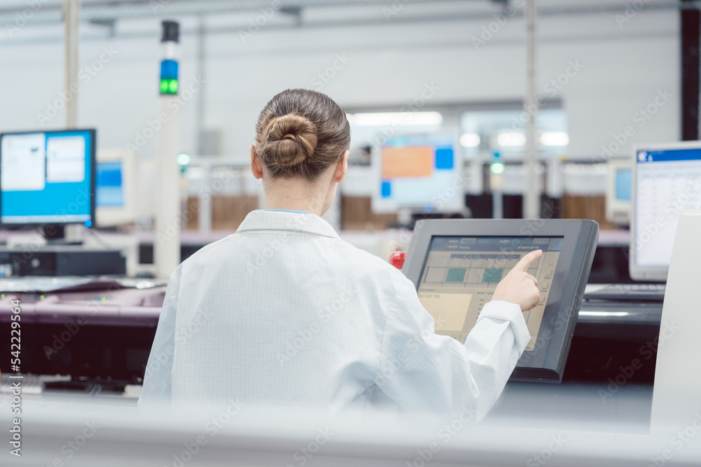Woman on control compute of assembly line in electronics factory Stock ...