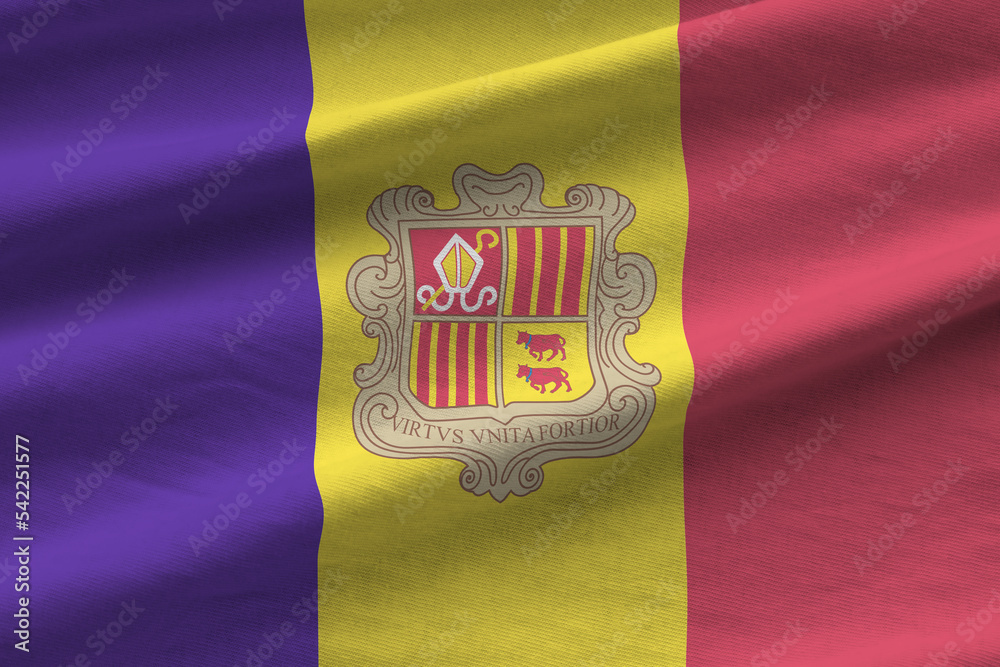Andorra flag with big folds waving close up under the studio light ...