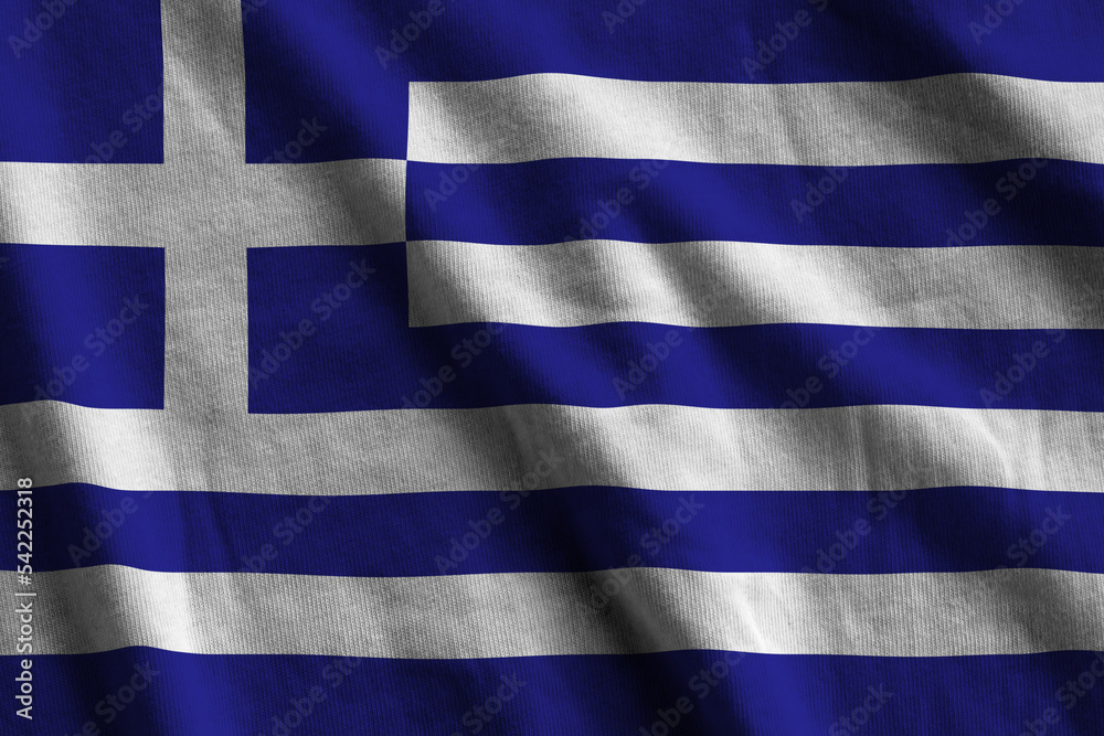 Greece flag with big folds waving close up under the studio light ...