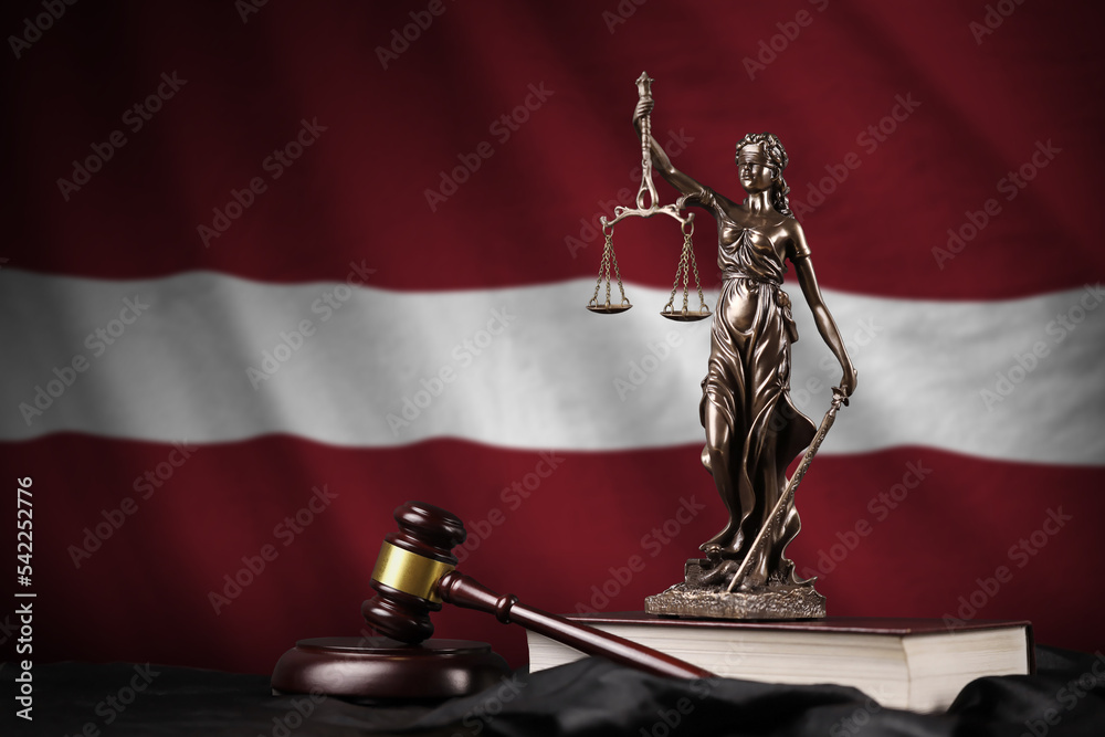Latvia flag with statue of lady justice, constitution and judge hammer ...