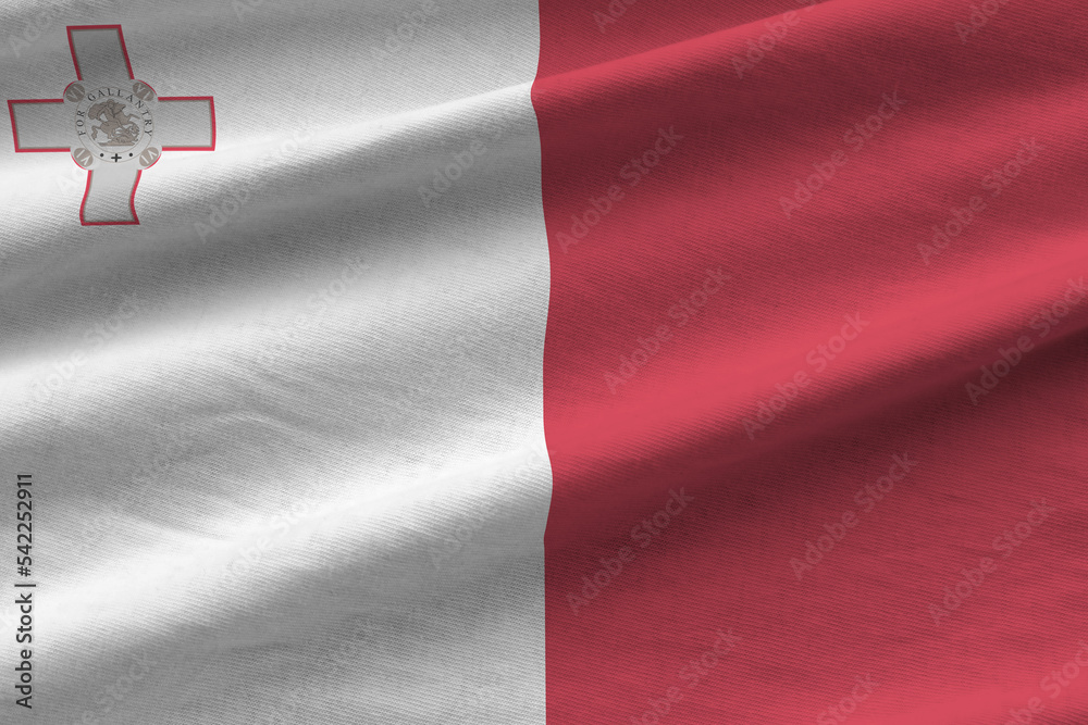 Malta flag with big folds waving close up under the studio light ...