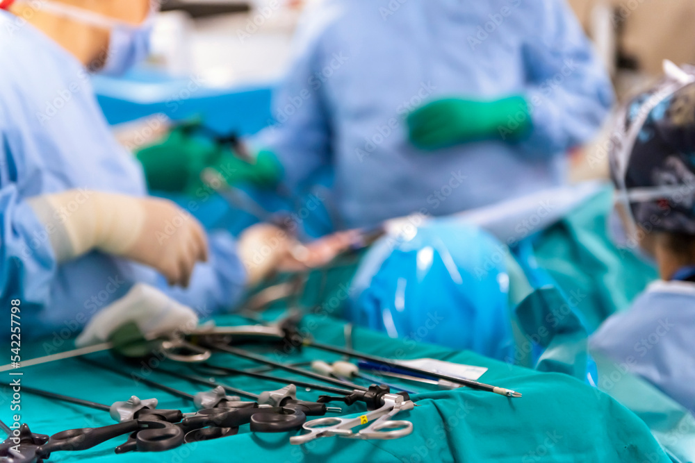 The surgeon's holing the instrument in abdomen of patient. The surgeon ...