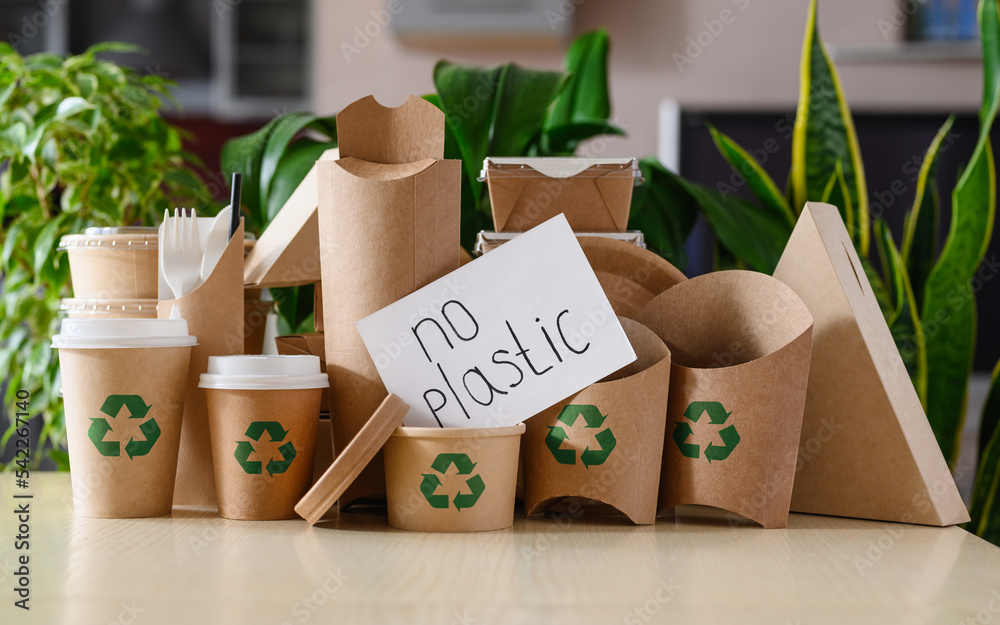 Paper eco-friendly disposable tableware with recycling signs on the ...