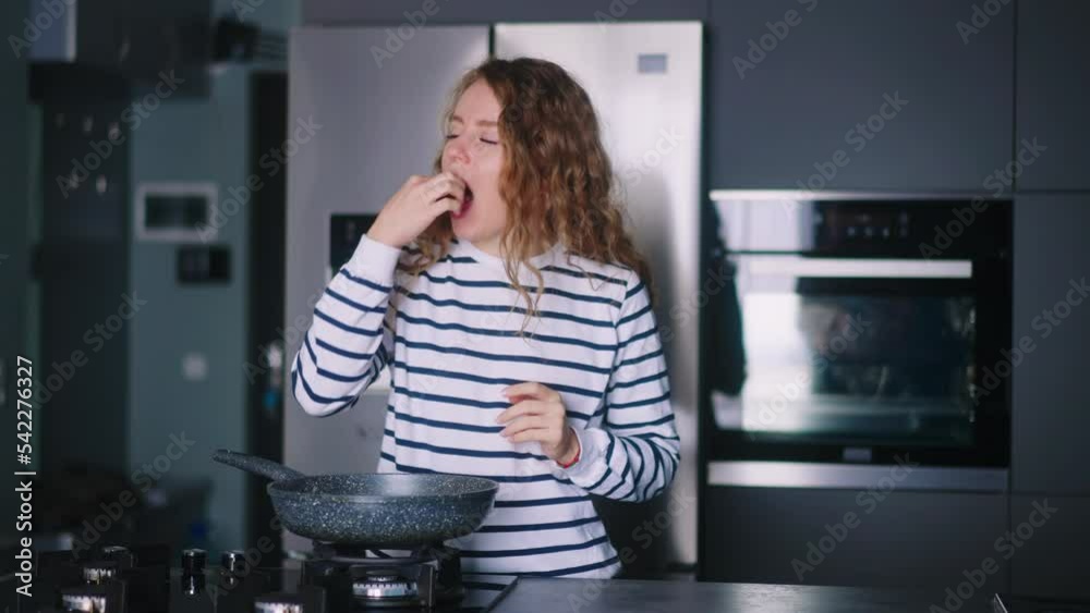 Woman eats unhealthy fried food from a pan, suffers from severe stomach ...