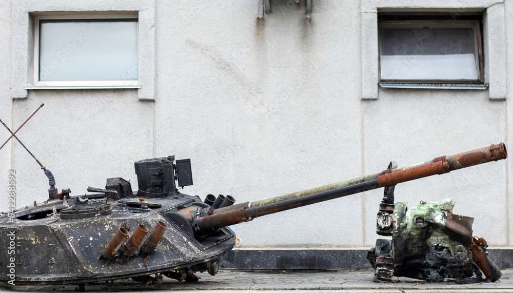 War in Ukraine. Destroyed tank with a torn off turret with a V on it ...
