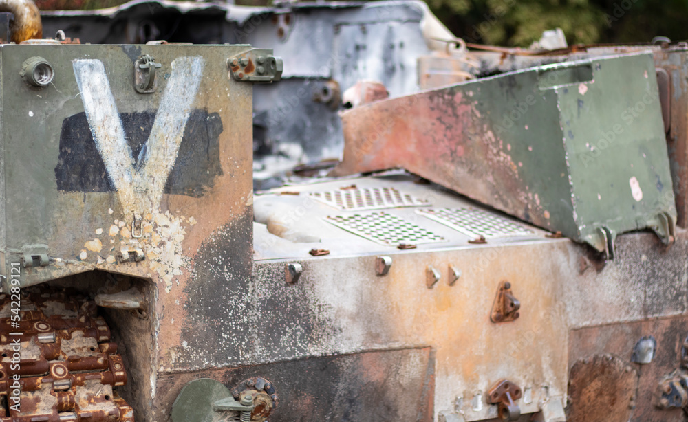 Destroyed, wrecked and burned T-72 tank with a designation V on it ...