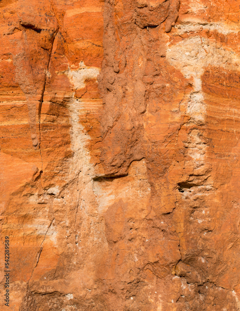 Sedimentary rocks with a high content of iron oxide. Red soil, loam ...