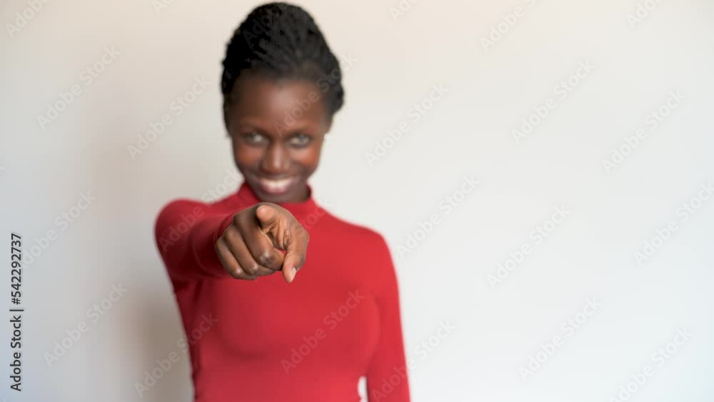 A young woman looking and pointing at the camera. Stock Video | Adobe Stock
