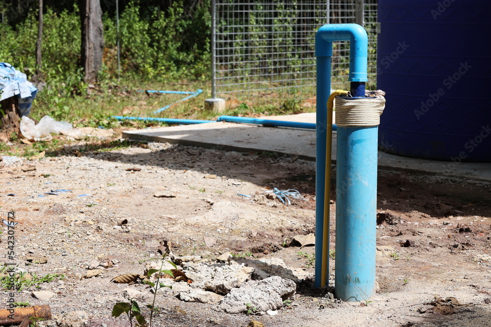 PVC pipes of underground wells. Rural artesian well with photovoltaic ...