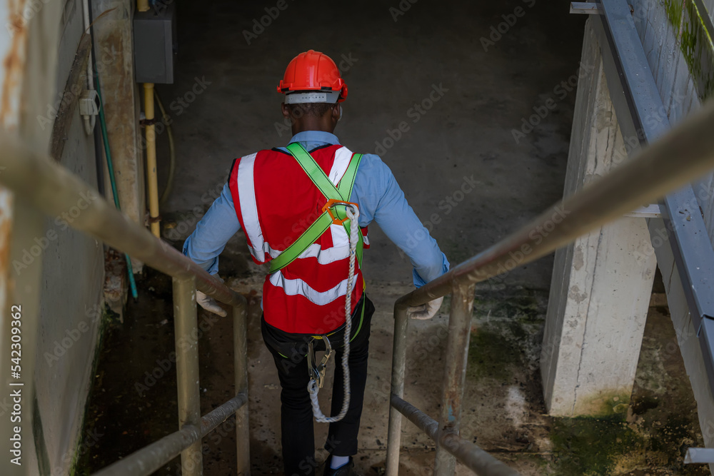 Construction worker wearing safety harness and safety line working at high place,Practices of ...