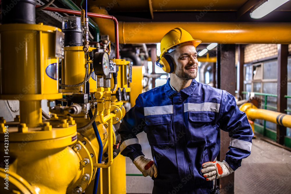 Power generation plant worker controlling crude oil and gas processing ...