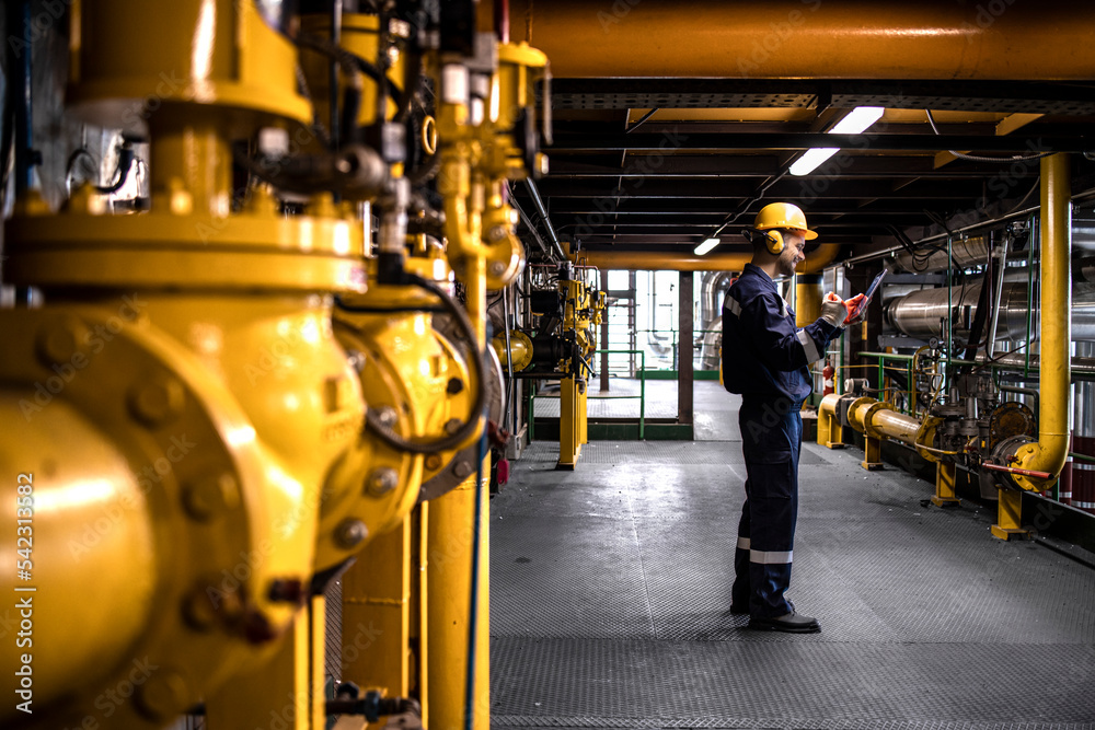 Petrochemical worker controlling process of crude oil production inside ...