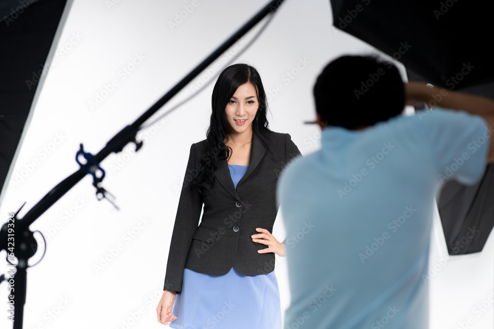 Back view professional photographer holding camera working in studio ...
