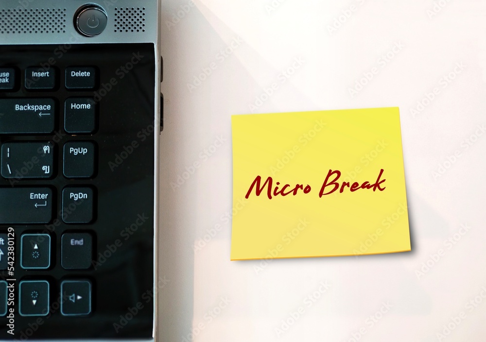 Laptop with stick note written Micro break, means to take a tiny short ...