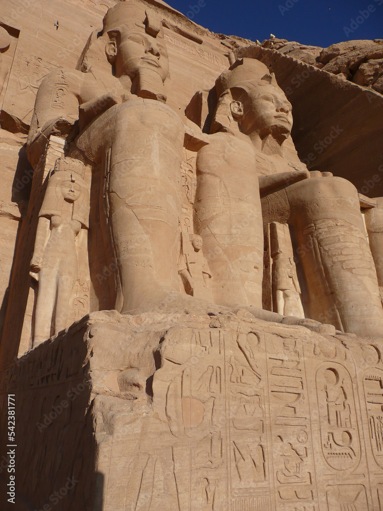 Statues depicting Ramses II seated on a throne wearing the double crown ...