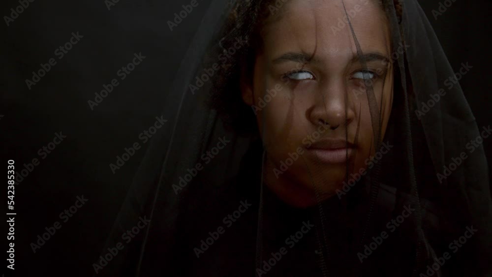 Close-up studio portrait footage of scary young African American woman ...
