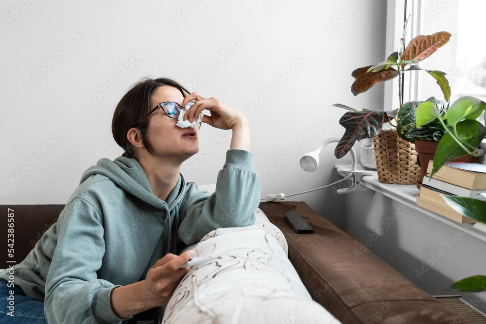 Young frustrated sick woman ill from common cold and flu virus ...