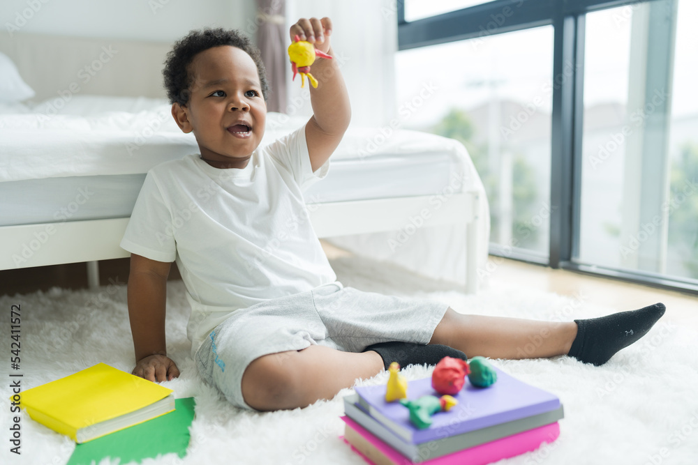 Cute little boy making things from plasticine on the ground Follow your ...
