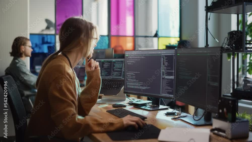 Caucasian Woman Writes Lines of Code on Desktop PC with Multiple ...