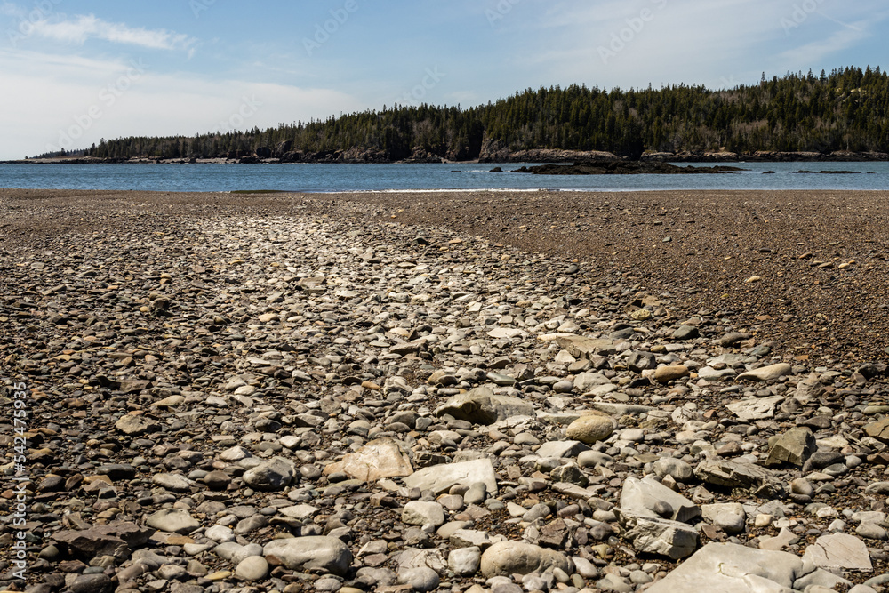 Light rock on Jasper Beach shows the path of a dry creek bed near Bucks ...