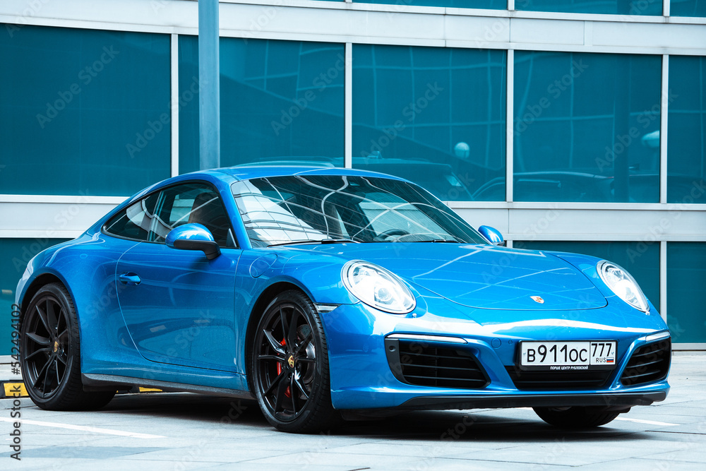 Front side view of car Porsche 911 in city area. Blue luxury Porsche ...