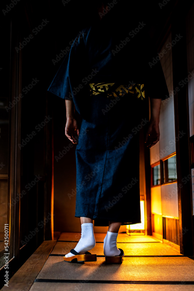 Unrecognizable man in Japanese kimono walking with geta socks and tabi ...