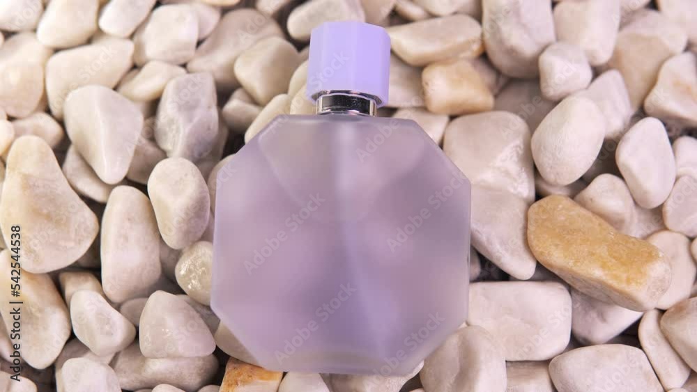 Transparent bottle of perfume on a white marble stones background ...