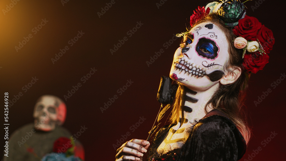 Beautiful model wearing death costume and flowers wreath over studio ...