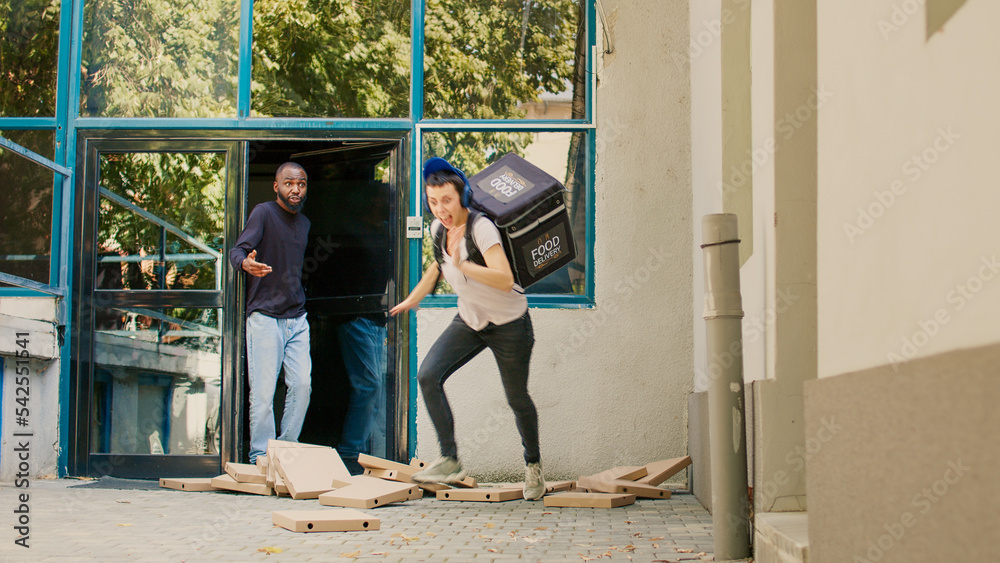 Fastfood delivery person dropping pizza boxes stack at client front ...