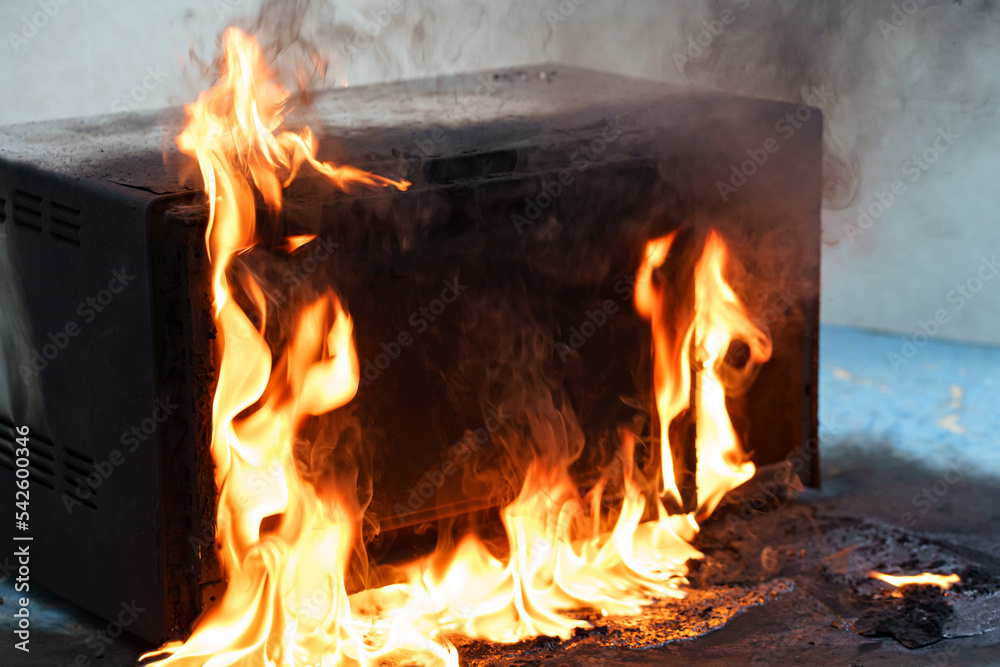 microwave oven on fire. the concept of fire in the kitchen and ...