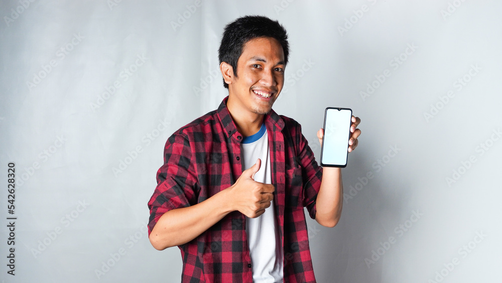 Adult Asian man wearing red flannel shirt smiling and give thumb up ...