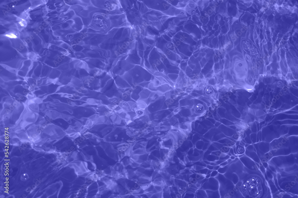 Defocus blurred transparent purple colored clear calm water surface ...