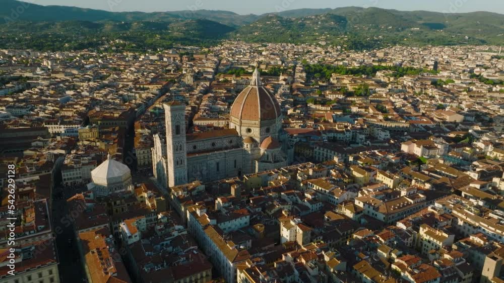 Fly above historic sights in old town at golden hour. Duomo di Firenze ...