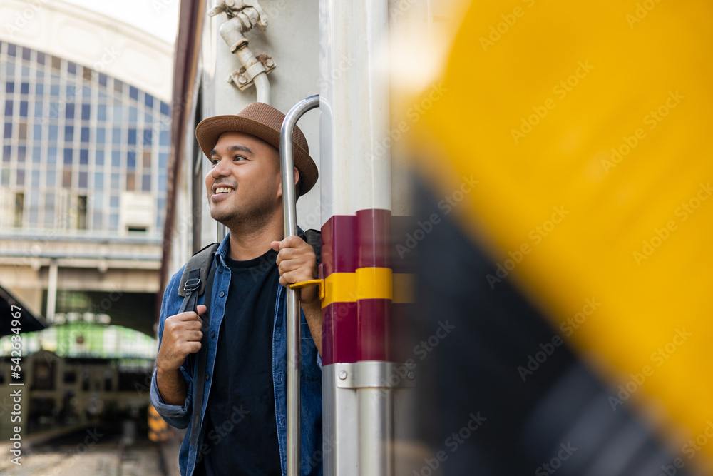Freedom traveler young asian man hanging handrail on train to ...