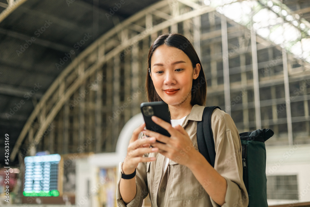 Traveler young asian woman using cellphone booking trip at terminal ...