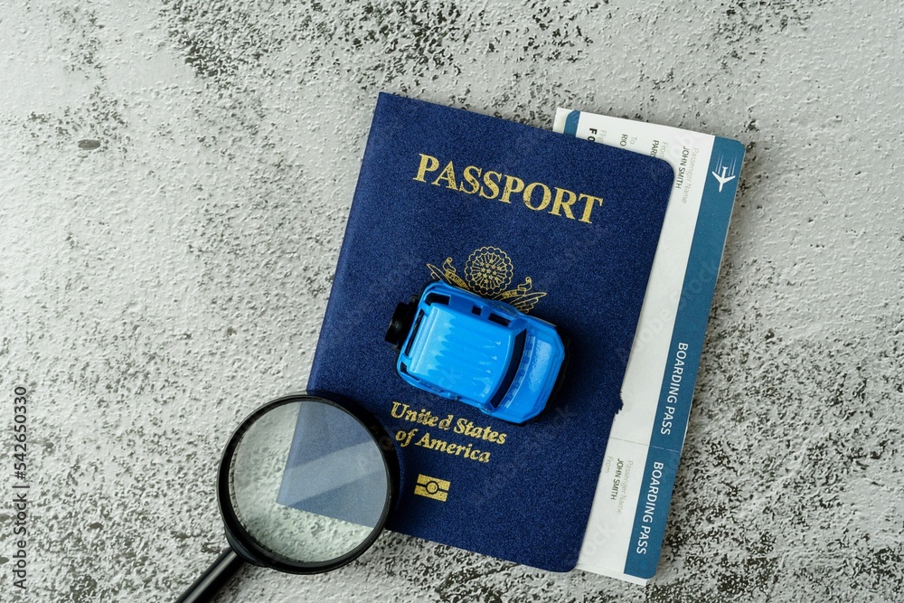 US passport on a map of the world and a magnifying glass simulating the ...
