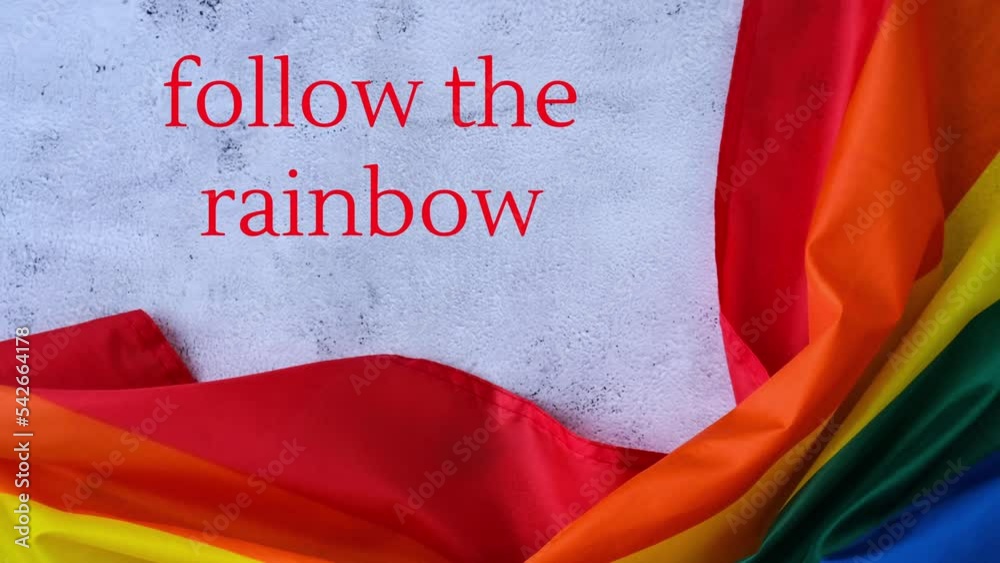 4k zoom in out Rainbow flag with text FOLLOW THE RAINBOW message ...