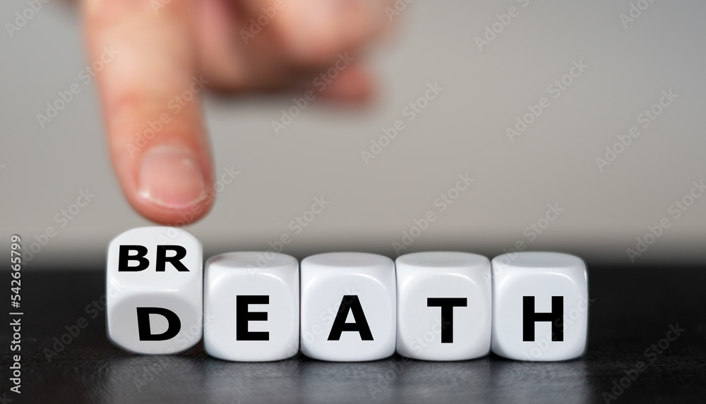 Hand turns dice and changes the word death to breath. Symbol for ...