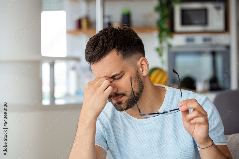 Tired man taking off glasses rubbing dry irritated eyes to relieve pain ...
