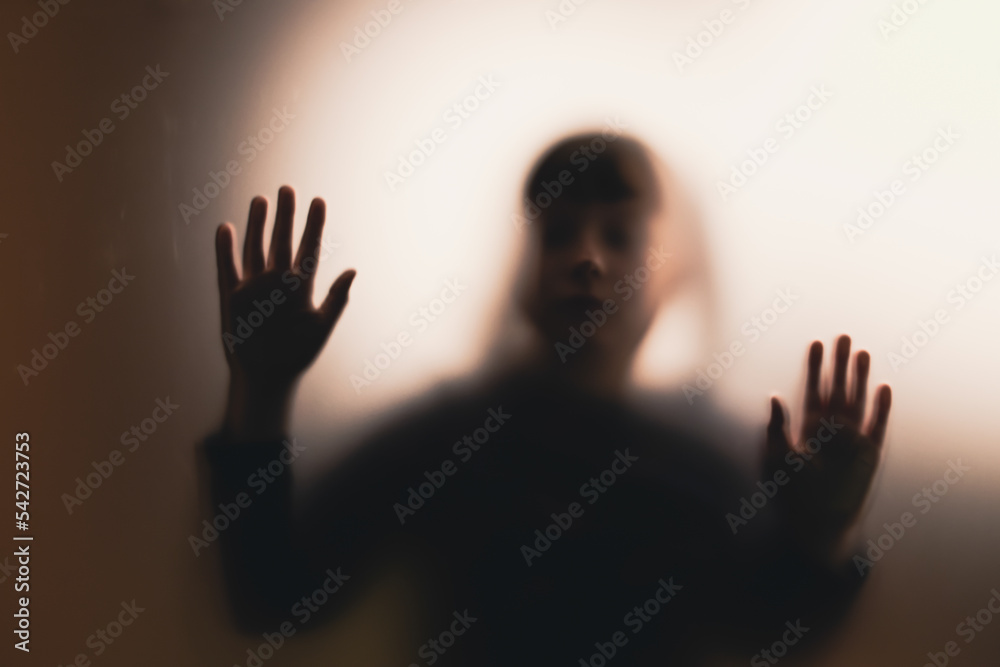 Shadowy figure, child behind glass - horror background Stock Photo ...