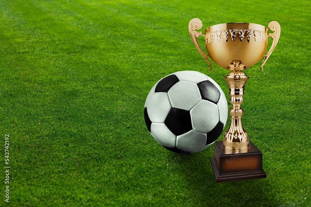 Classic football ball and golden trophy at the stadium. Stock Photo ...