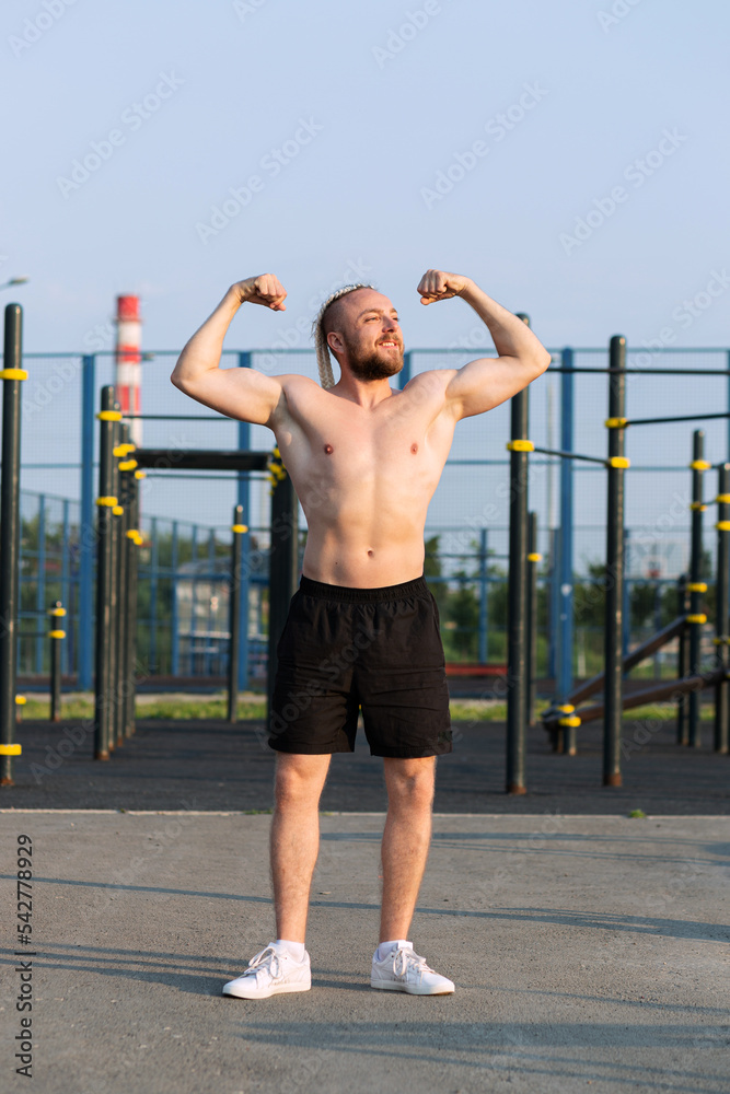 In the morning at sunrise, a man with an interesting braid hairstyle ...