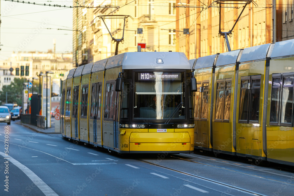 Berlin, Germany - October 7, 2022: Yellow tram drives along a street ...
