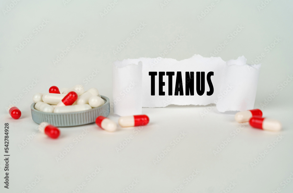 On a gray background, medical capsules and a paper plate with the ...